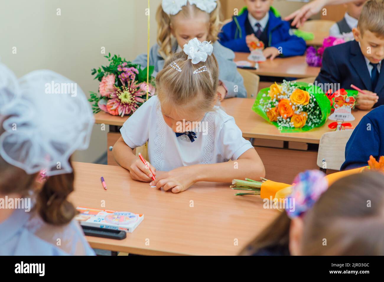 First-grade students and teacher are in school classroom at first ...