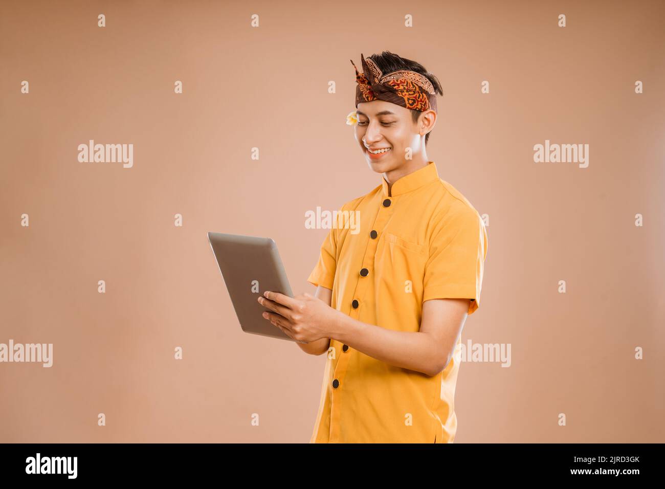 portrait of balinese young man using tablet pc Stock Photo - Alamy