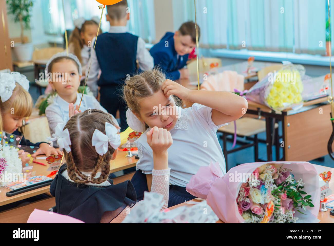 First-grade students and teacher are in school classroom at first ...