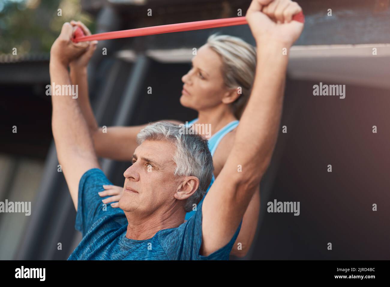 Stay motivated no matter what. a mature man stretching his arm muscles with an elastic band ...