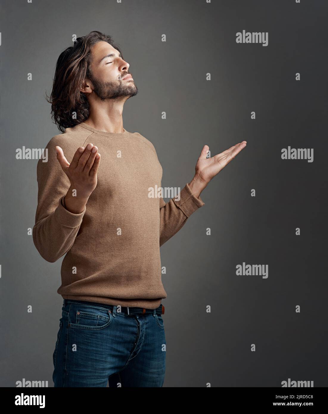 Praising His presence. Studio shot of a handsome young man praying ...