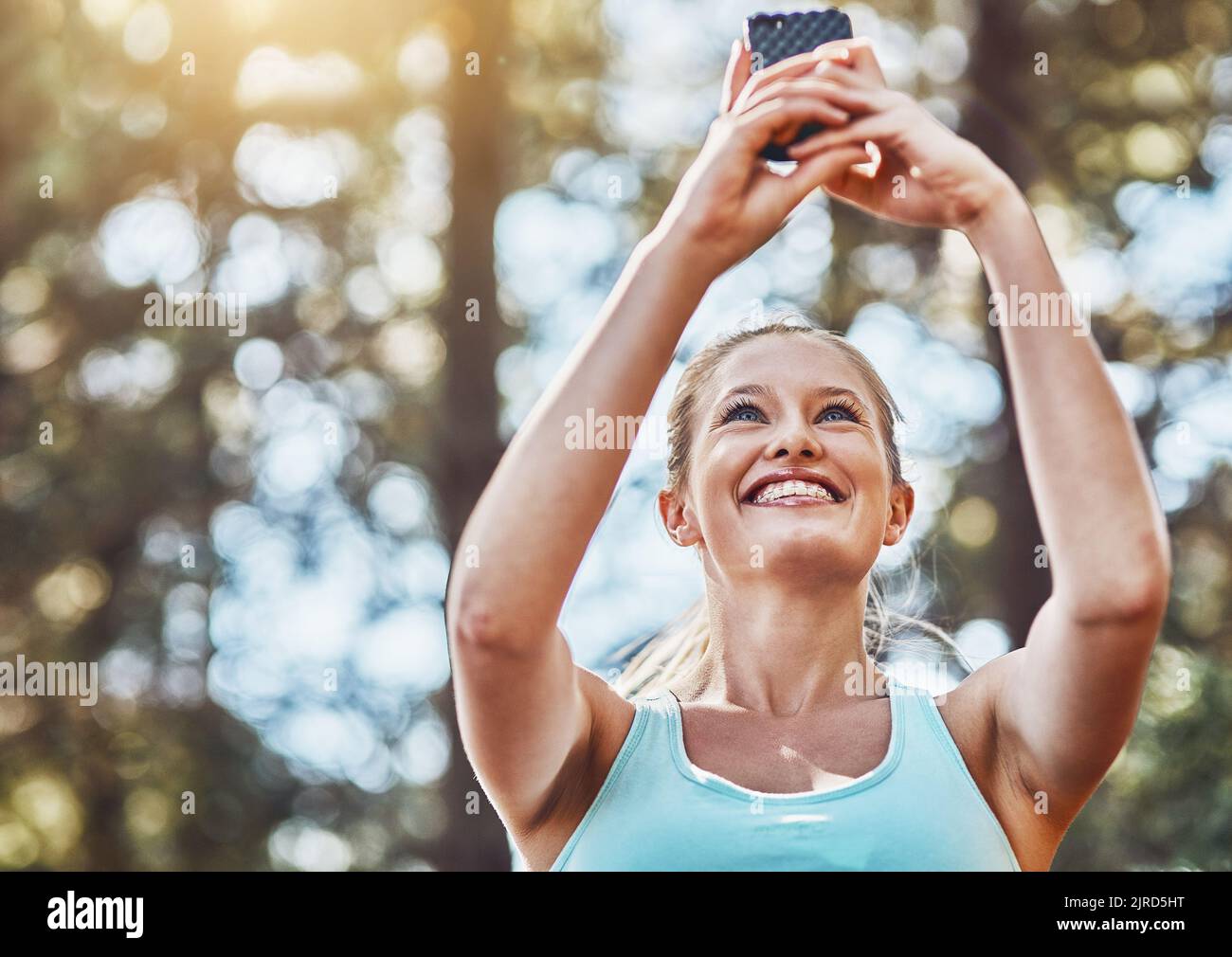 The selfie before I start sweating. a young woman taking a photo of ...