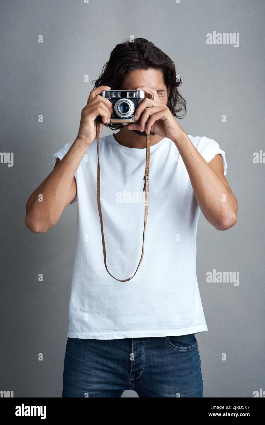 One click, a lot of memories. Studio portrait of a young man posing ...