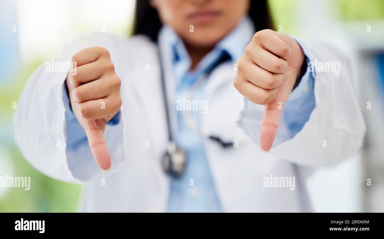 Doctor with thumbs down hand sign in healthcare hospital or lab for ...