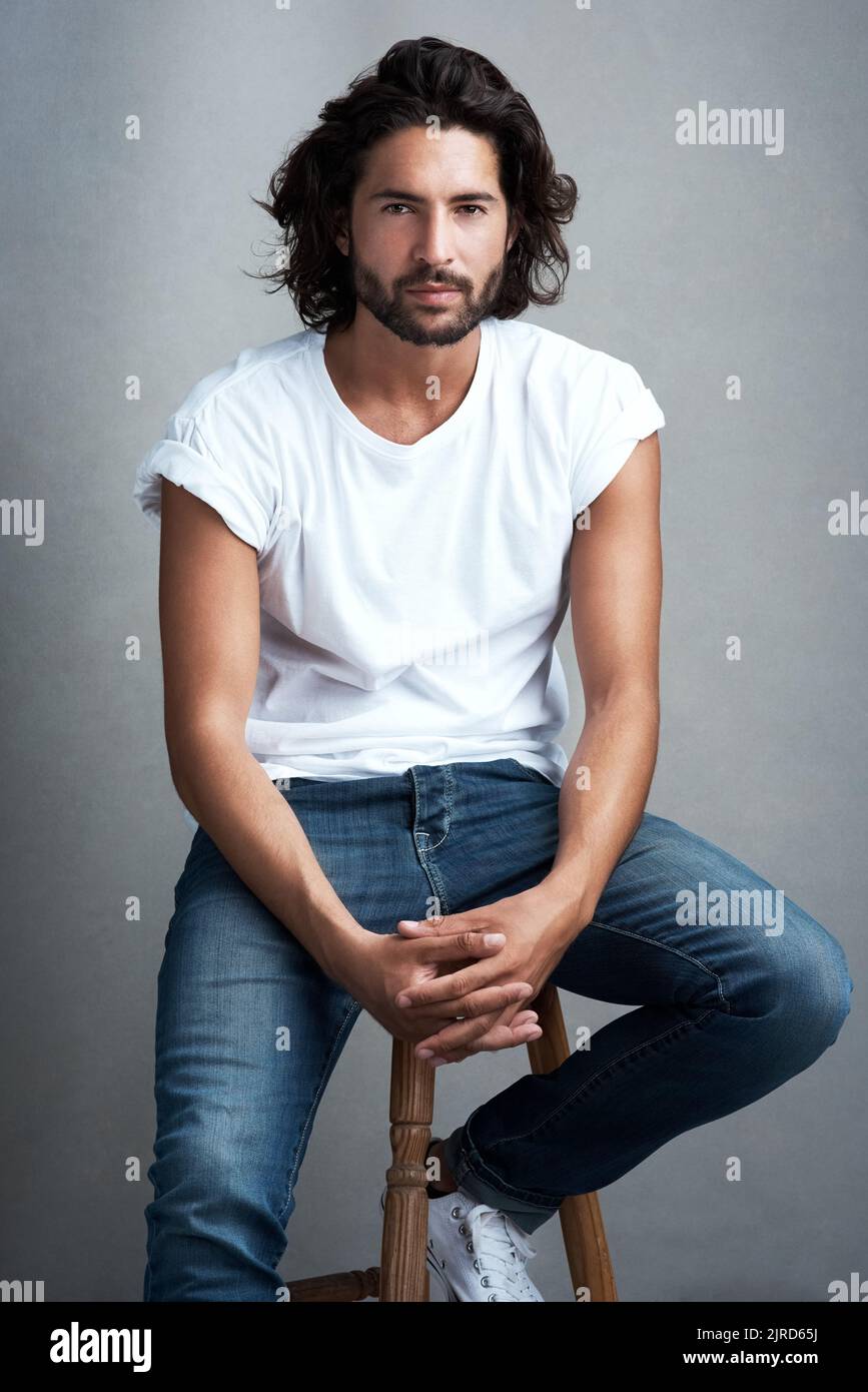 Keeping his style simple but smooth. Studio shot of a handsome young ...