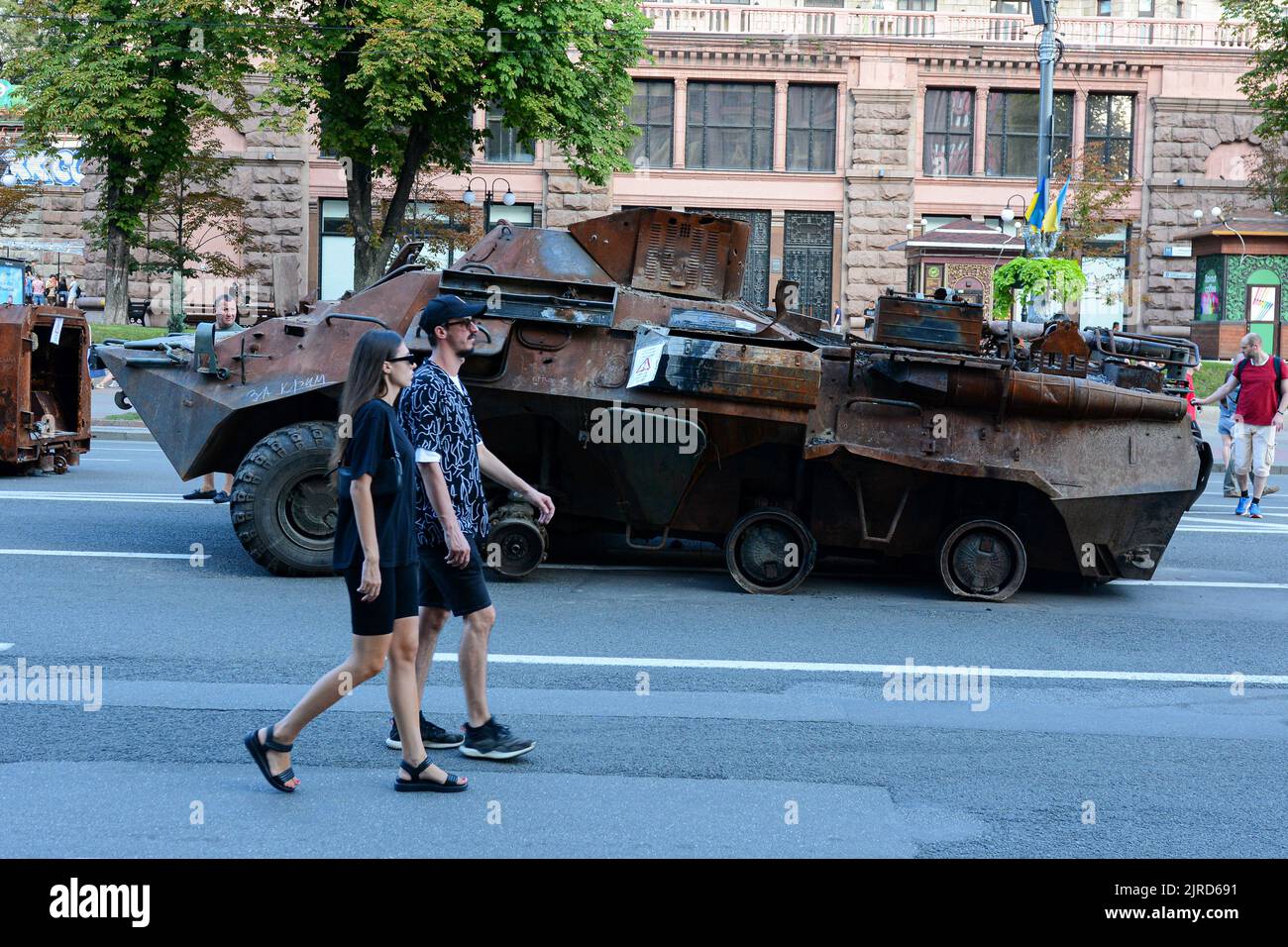 People walk by the destroyed Russian army equipment displayed at ...
