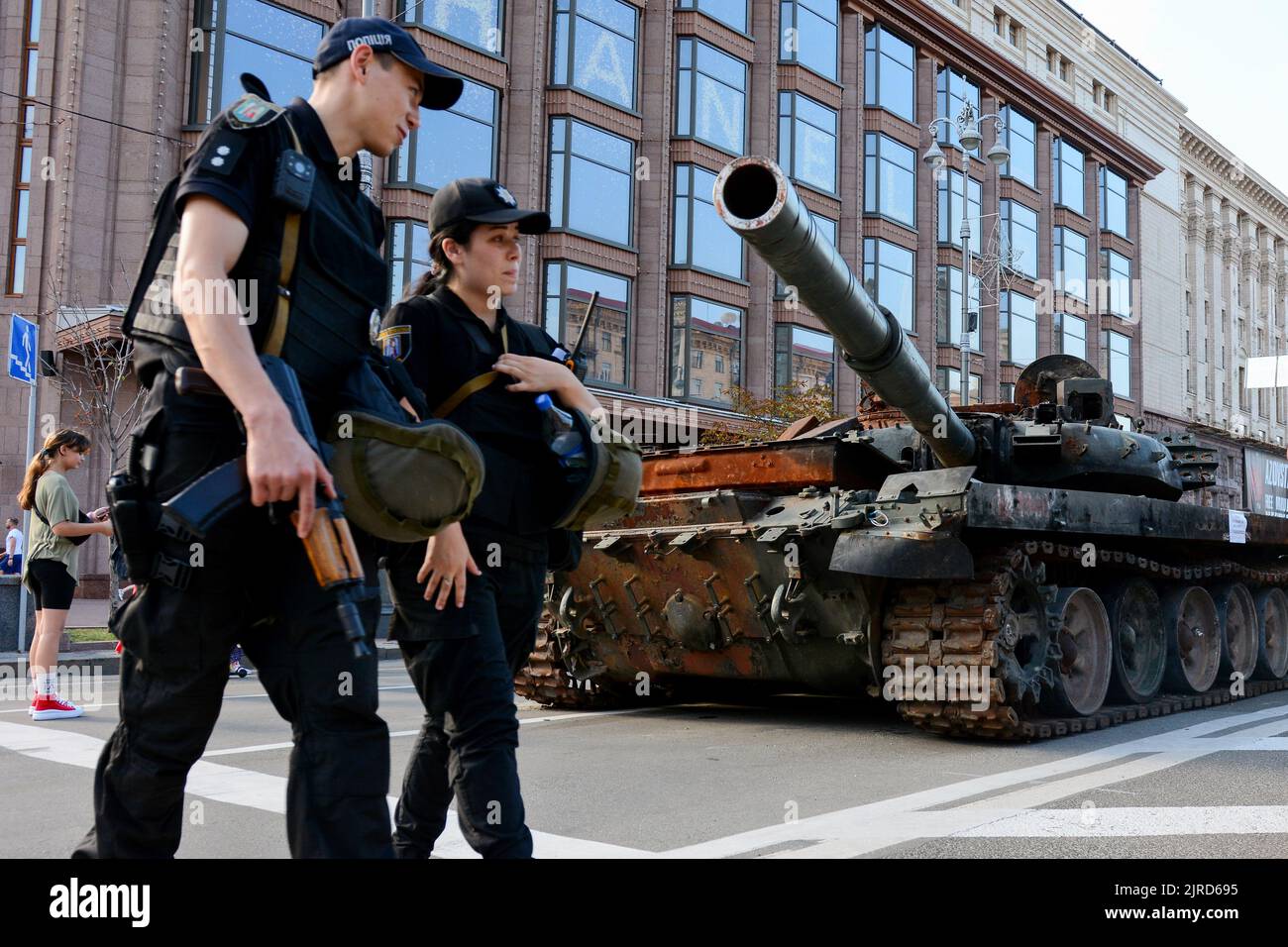 Policemen walk by the destroyed Russian army, and equipment of the ...