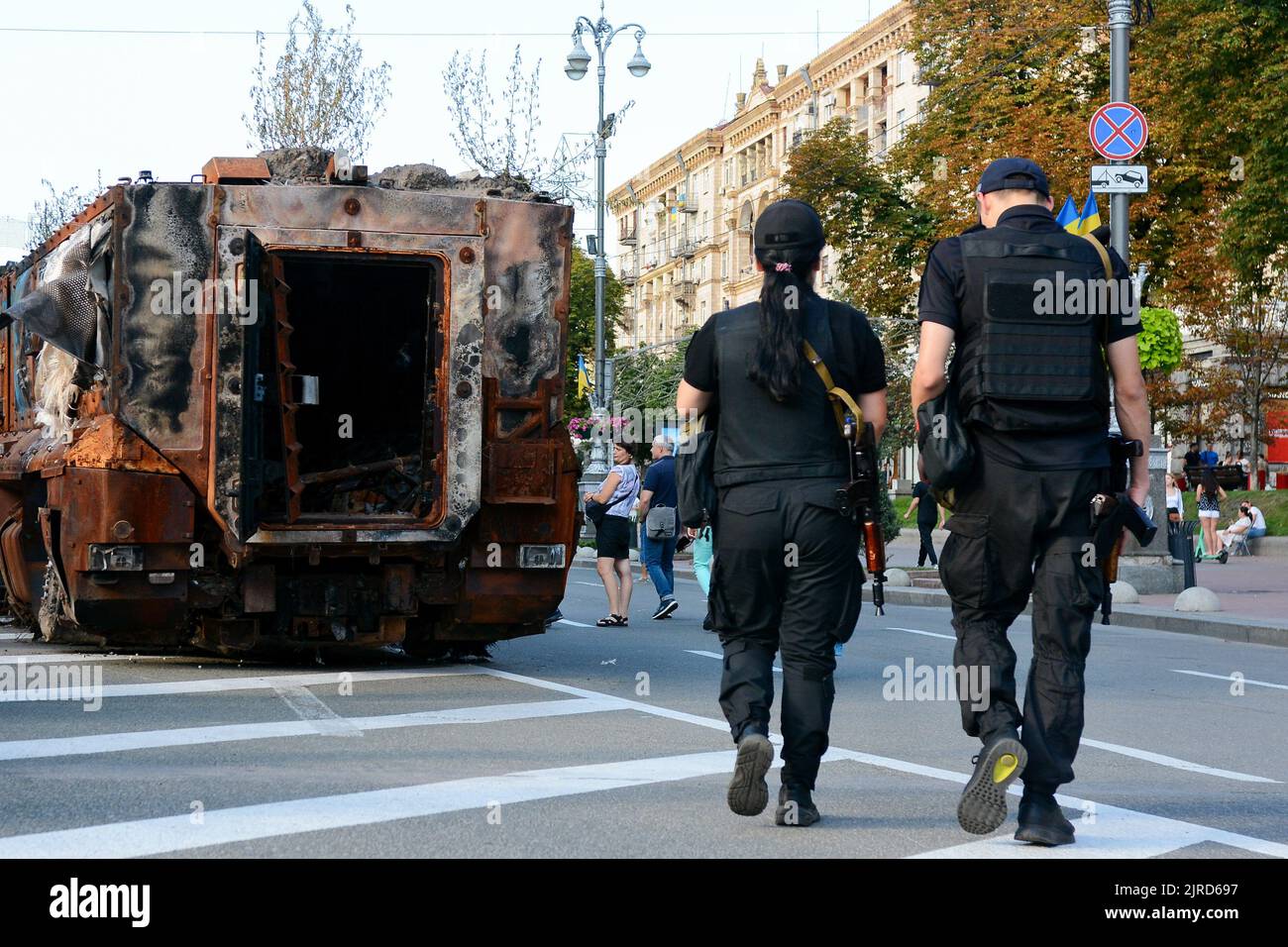 Policemen walk towards the destroyed Russian army, equipment of the ...