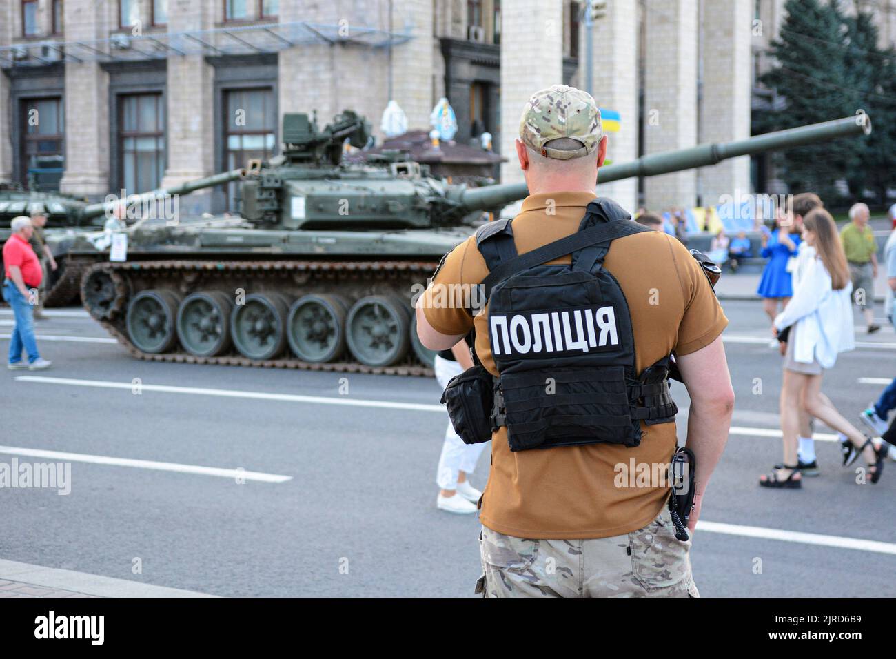 A policeman stands in front of destroyed Russian army equipment ...