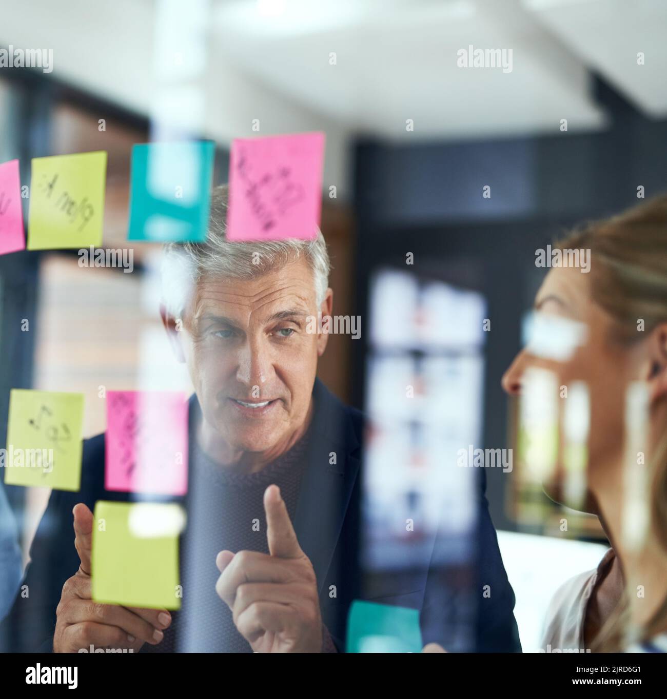 He knows what hes talking about. two colleagues having a brainstorming ...