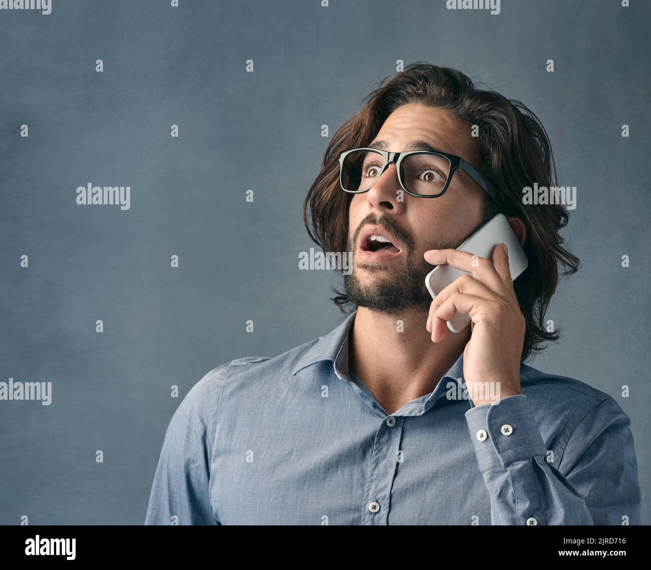 This is something you must see. Studio shot of a young man talking on ...