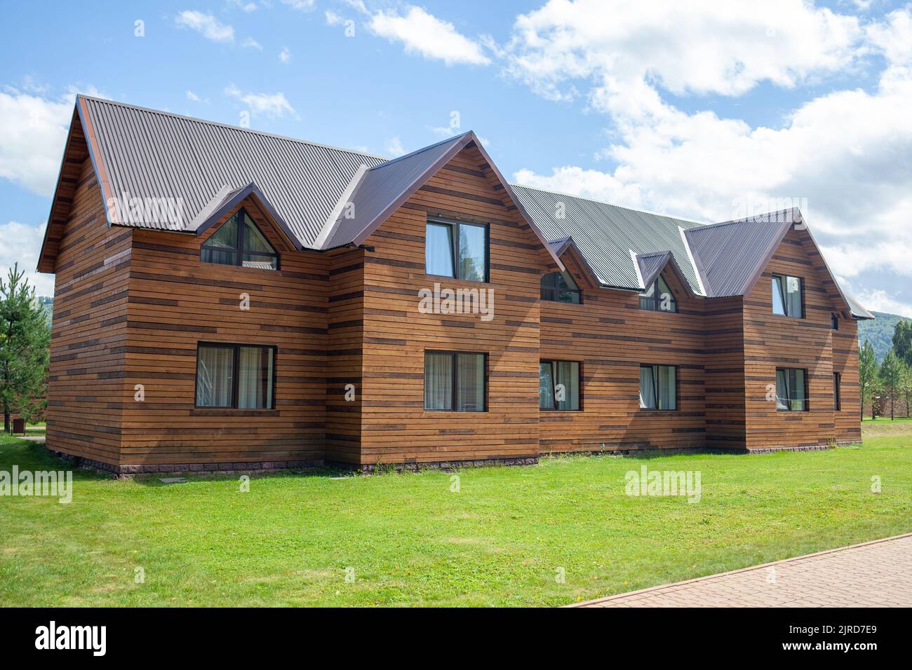 Two-storey wooden cottage with windows nature with a green lawn. Sale ...