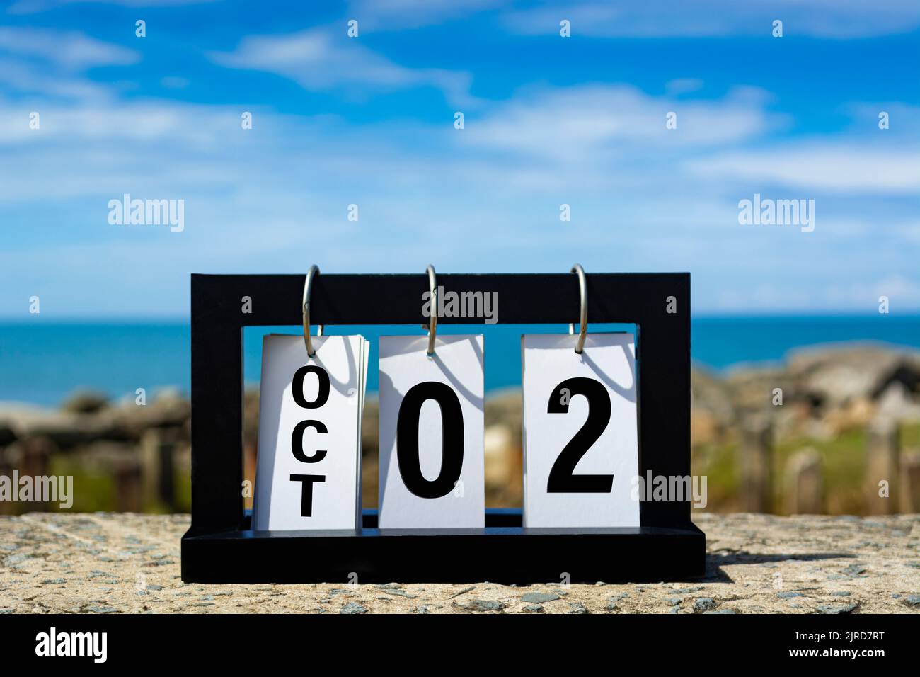 Oct 02 calendar date text on wooden frame with blurred background of ...