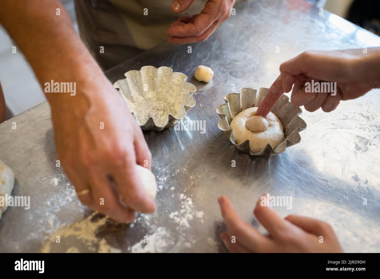 The process of making brioche in an artisan bakery. Laying the dough in ...