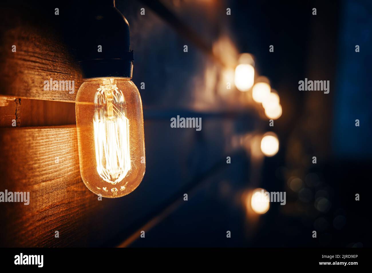 Antique incandescent Edison type bulb on wooden wall Stock Photo - Alamy