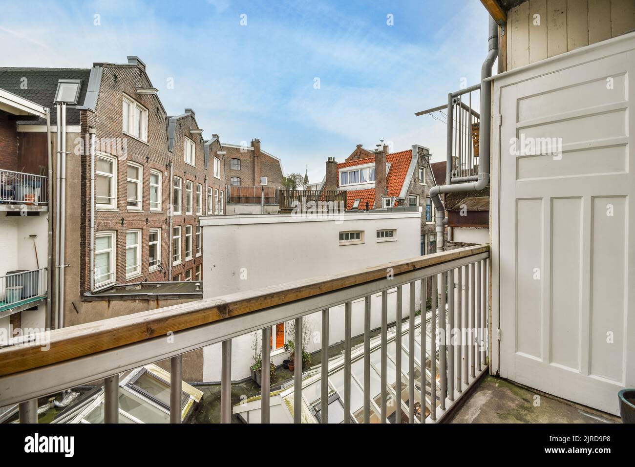 Front view of old brick buildings and cars with bicycles from small ...