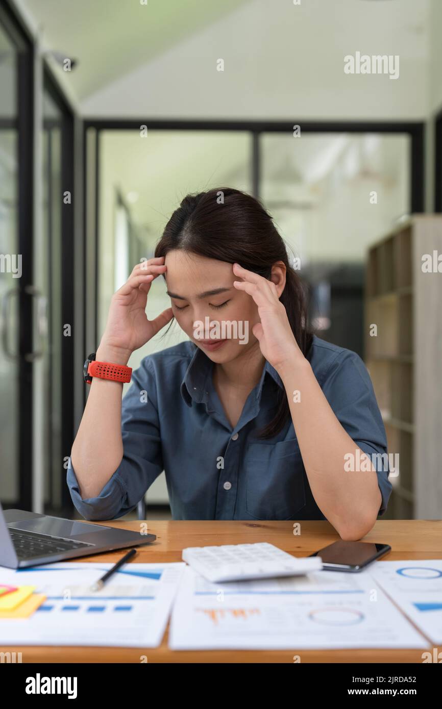 Headache, tired and stressed with financial problems desk. Professional ...