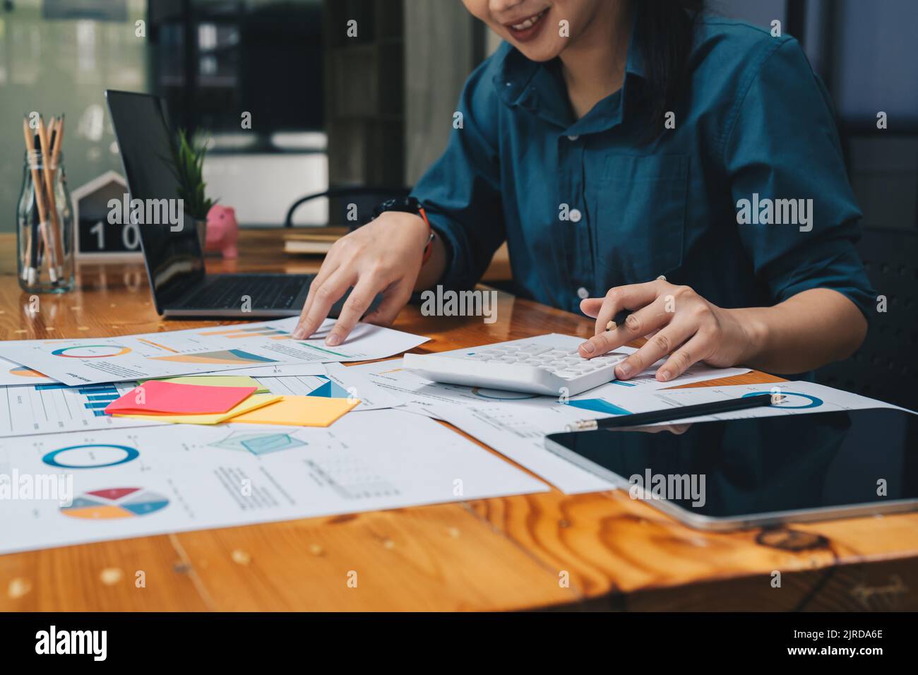 businesswoman working on desk office with using a calculator to ...