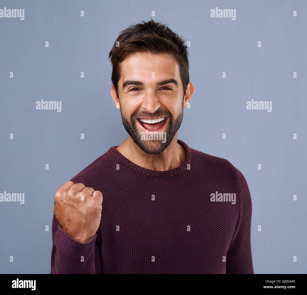 Yes Youve done it again. Studio shot of a handsome young man cheering ...