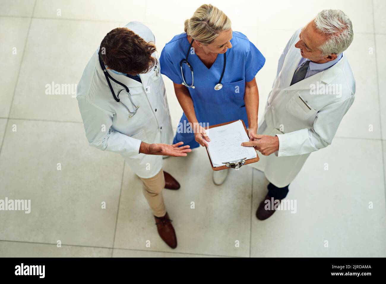Brainstorming their way to a cure. High angle shot of a team of doctors ...