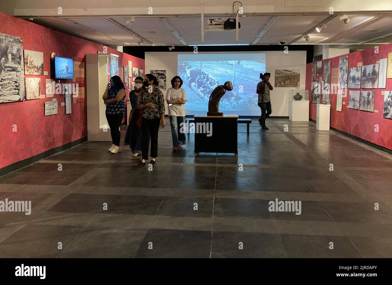 Visitors go past the exhibits displayed at Partition Exhibition to mark ...
