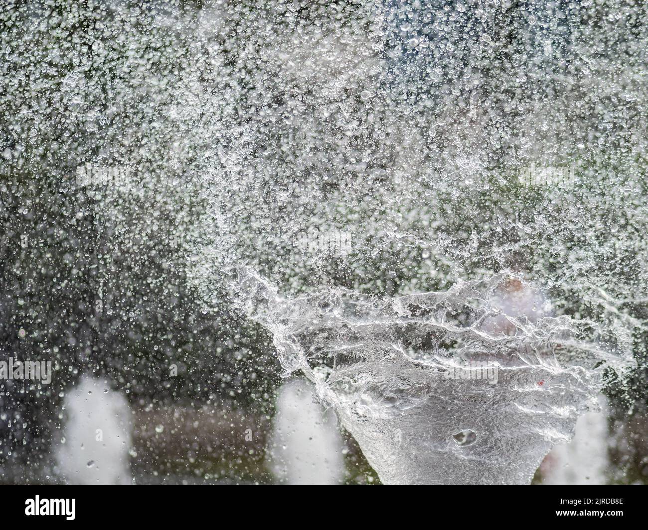 Water splashes from fountain on dark background. Natural texture of ...