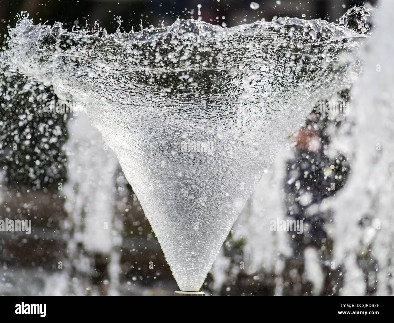 Water splashes from fountain on dark background. Natural texture of ...