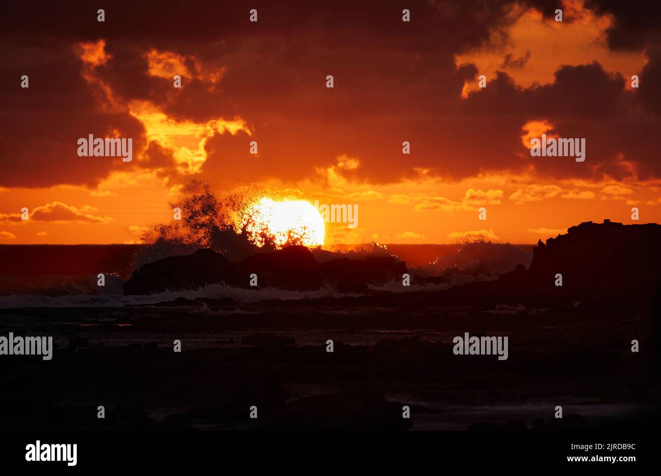 Bright orange scene of the sun setting down over Nosara peninsula ...