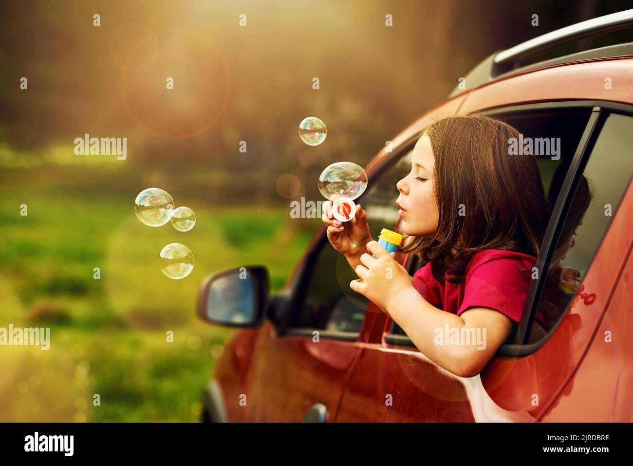 Nobodys gonna burst my bubble today. a playful little girl blowing ...