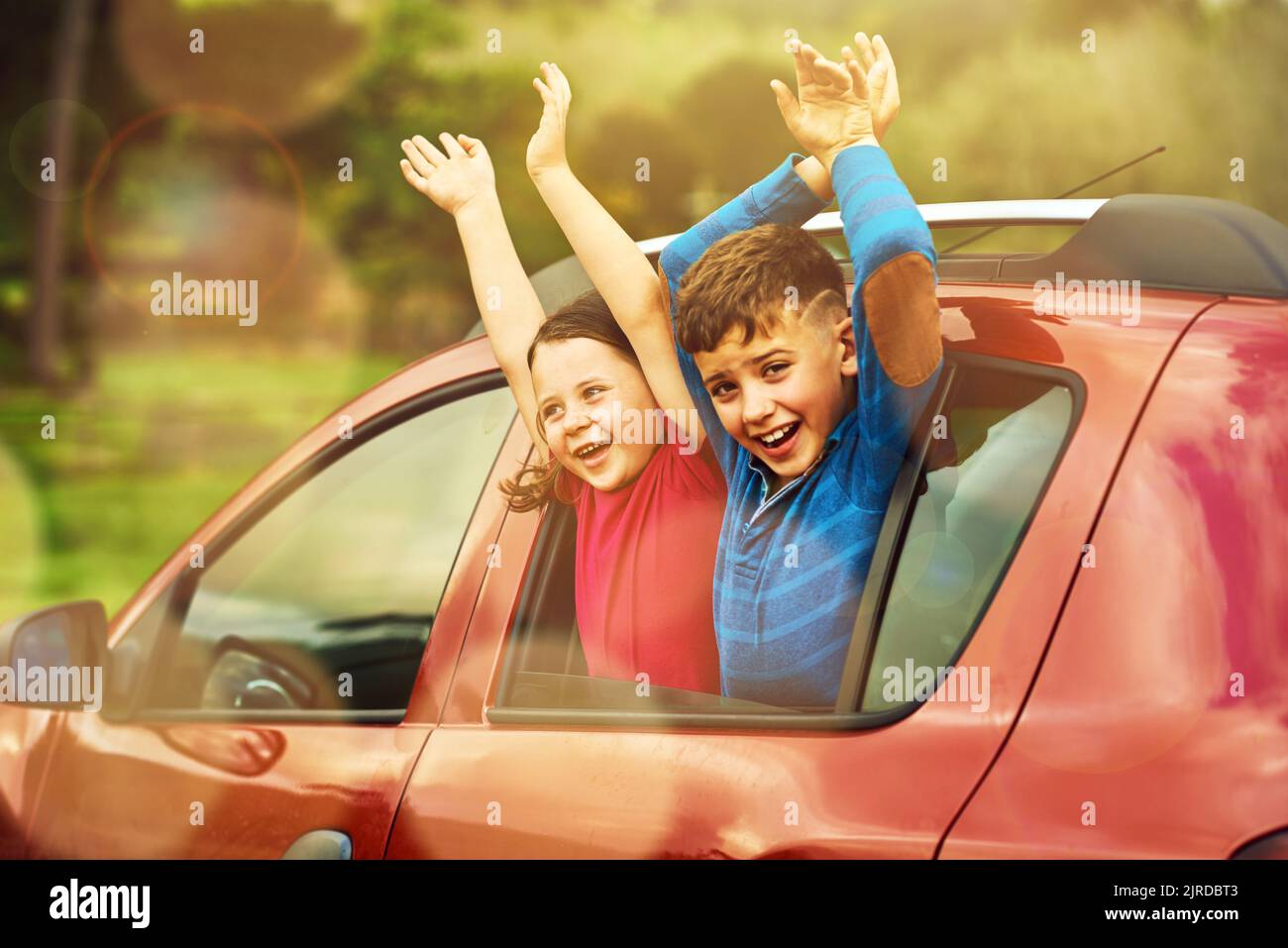 Yay, were here. two excited children leaning out of a car window ... Yay, were here. two excited children leaning out of a car window ...
