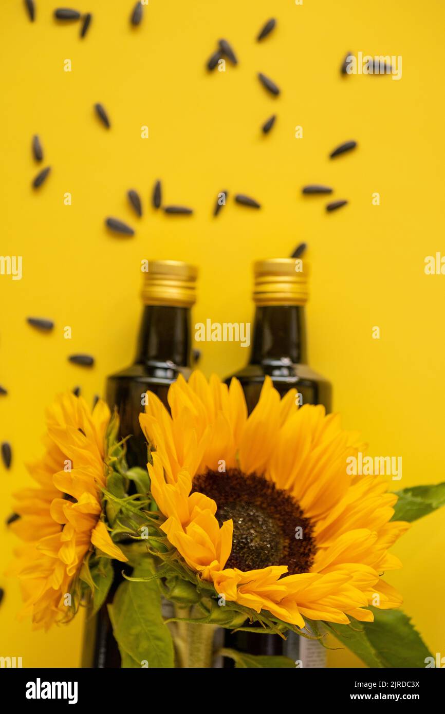 Sunflower oil. Oil bottles, scattered black sunflower seeds and ...