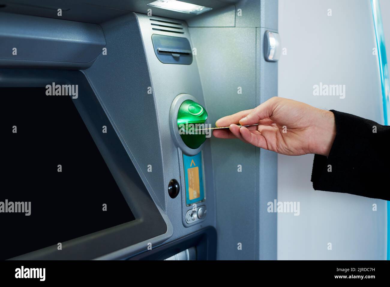 Drawing some cash from the ATM. a businessman making a transaction at ...