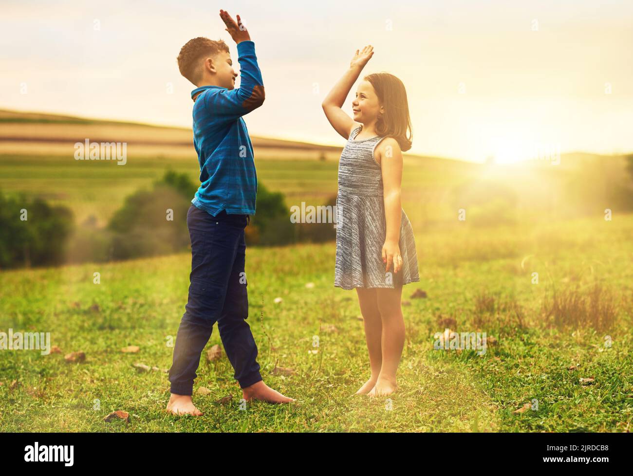 Nice one. a cute brother and sister high fiving each other while ...