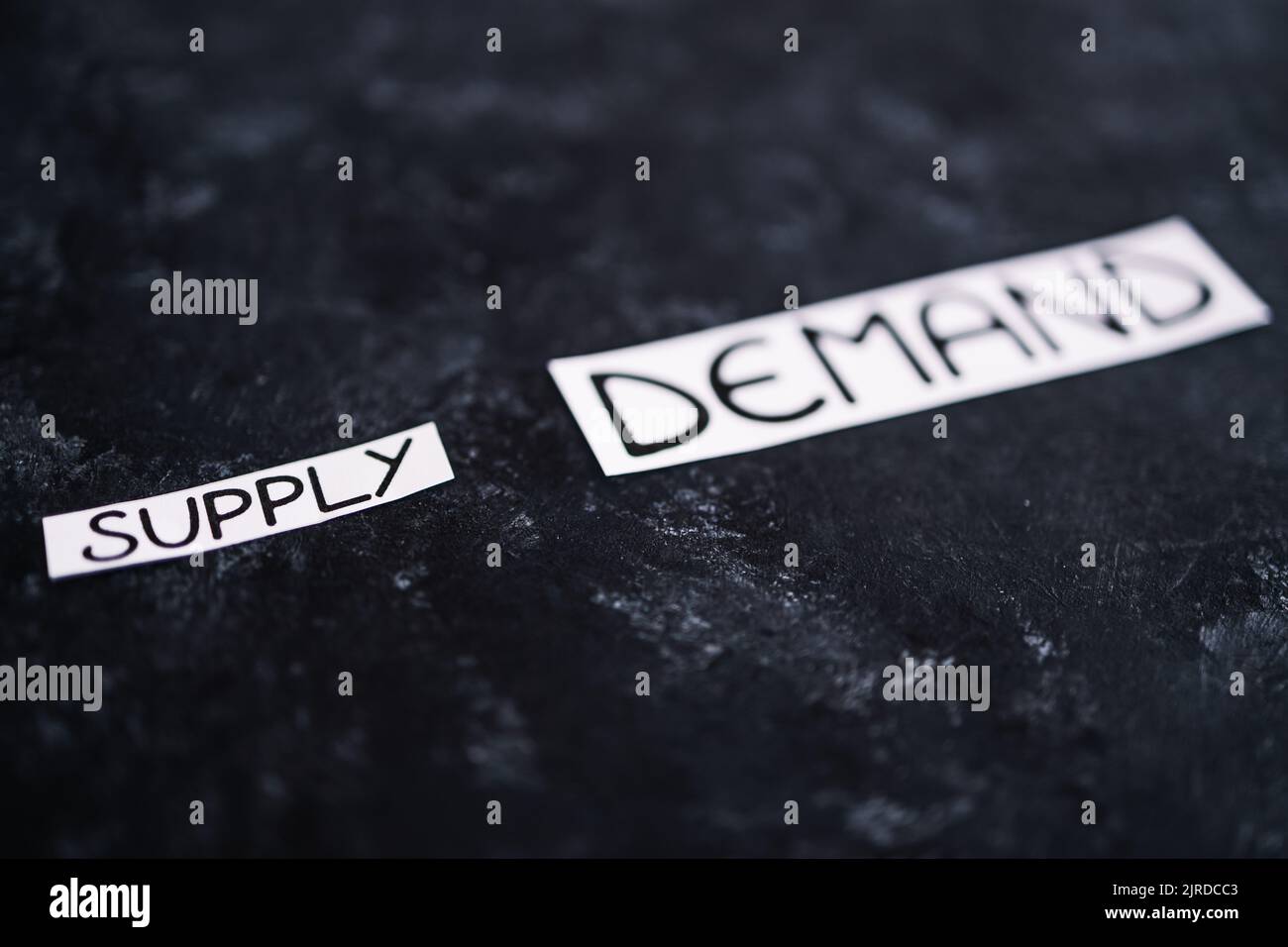 small Supply text and big Demand text on dark background, concept of ...