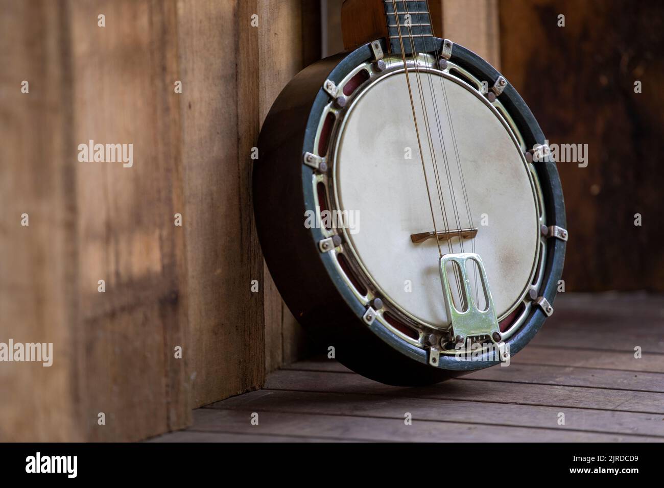 Close-up of a classic Banjo on a slight angle, on decking in the ...