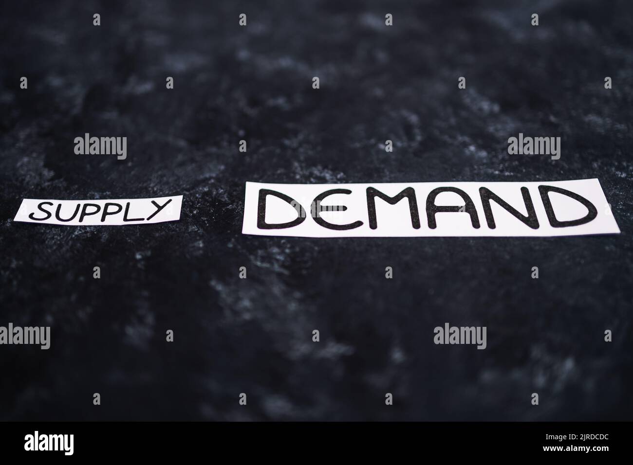 small Supply text and big Demand text on dark background, concept of ...