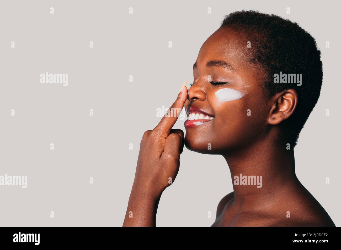 Free space for text. Profile view of an African woman touching her nose ...
