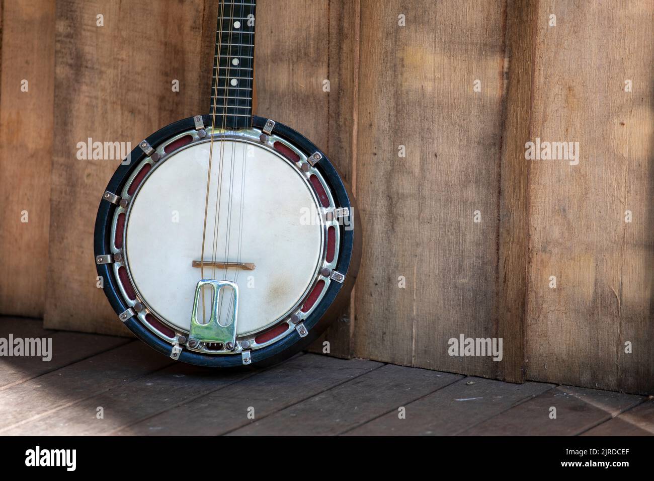 Vintage Banjo, close up of the body, in sunlight on a porch, wooden ...