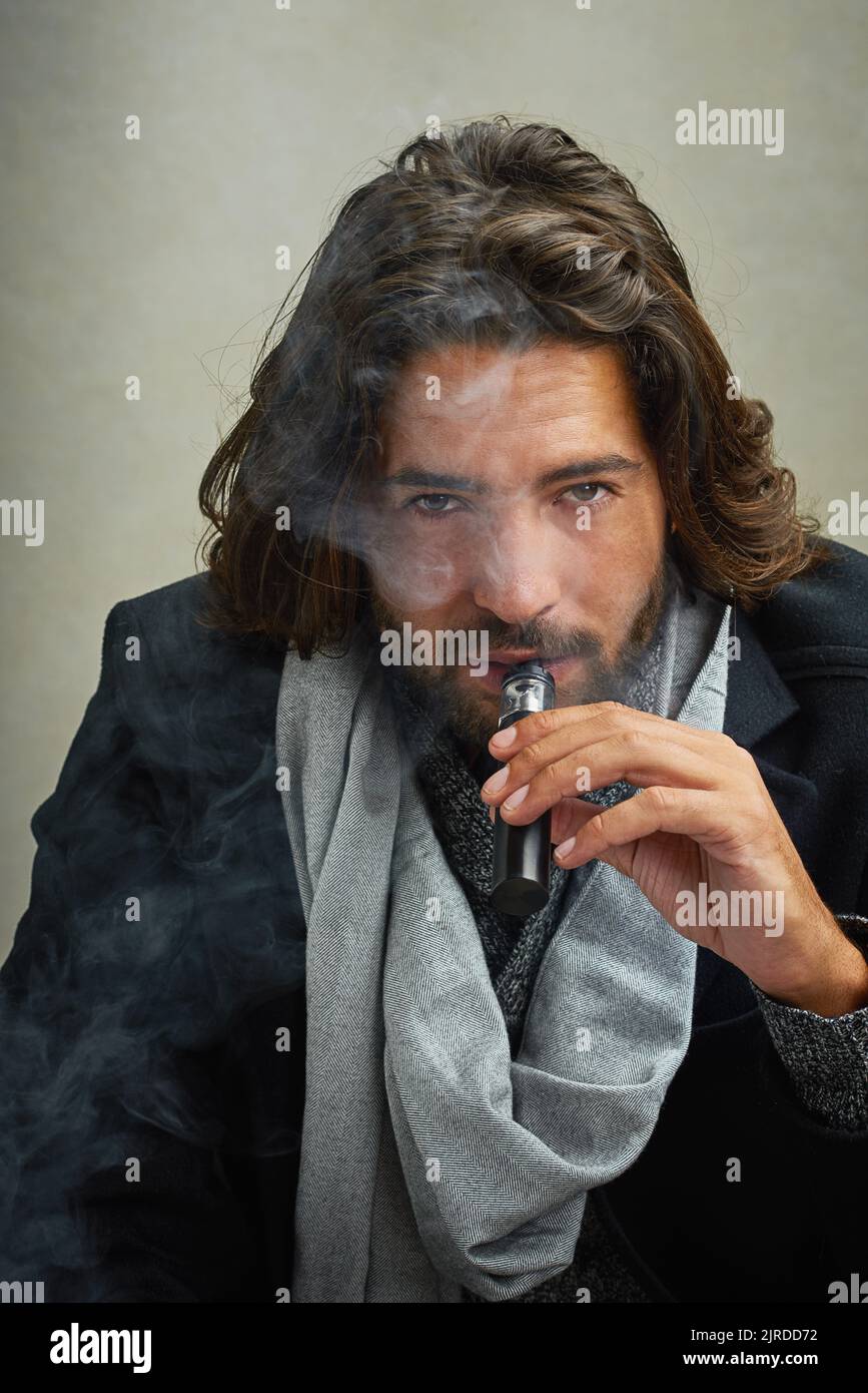 Cutting back on my nicotine intake. a stylishly dressed man smoking an ...