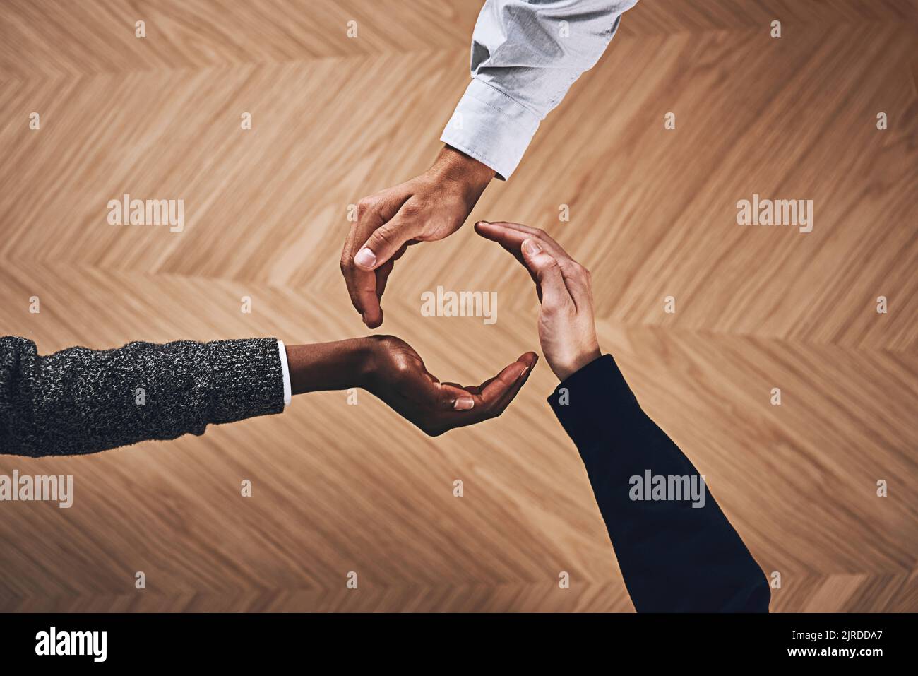 Teamwork creates a continuous circle of success. High angle shot of a ...