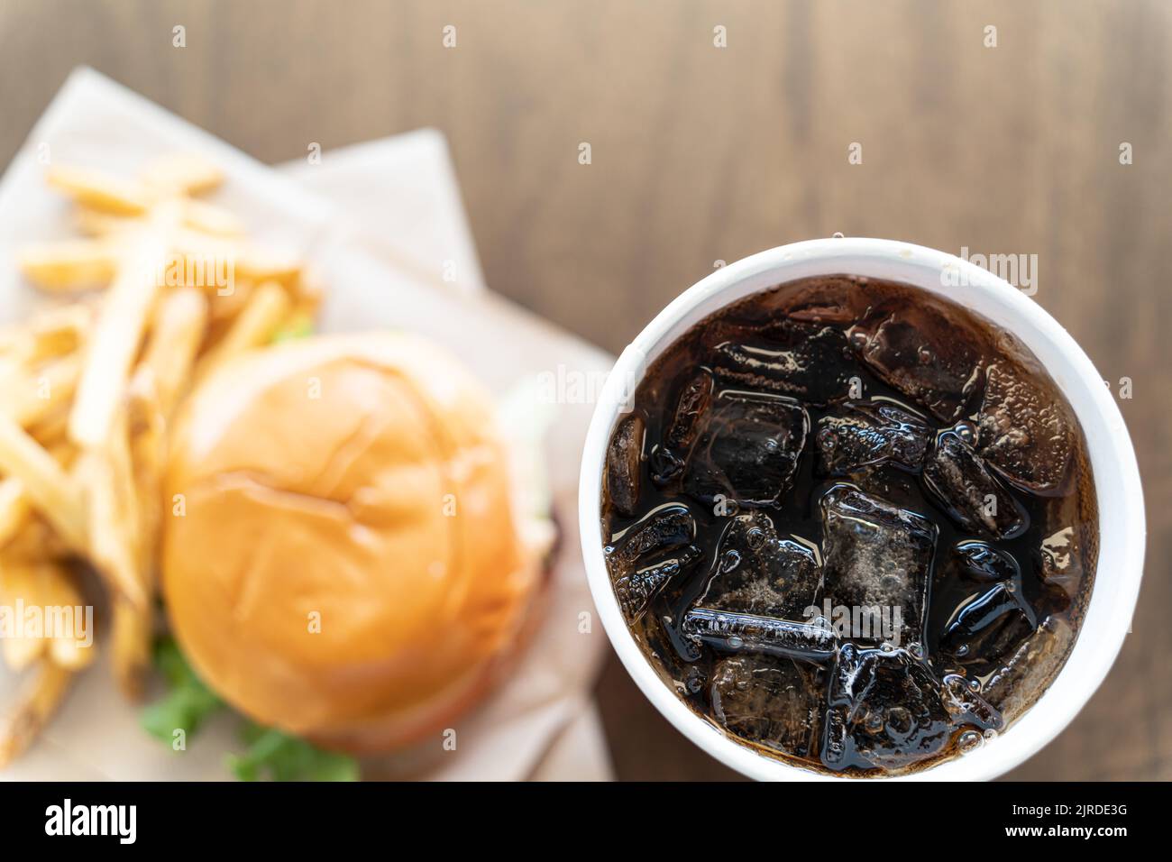 Burger and fries served with a ice cold Cola drink Stock Photo - Alamy