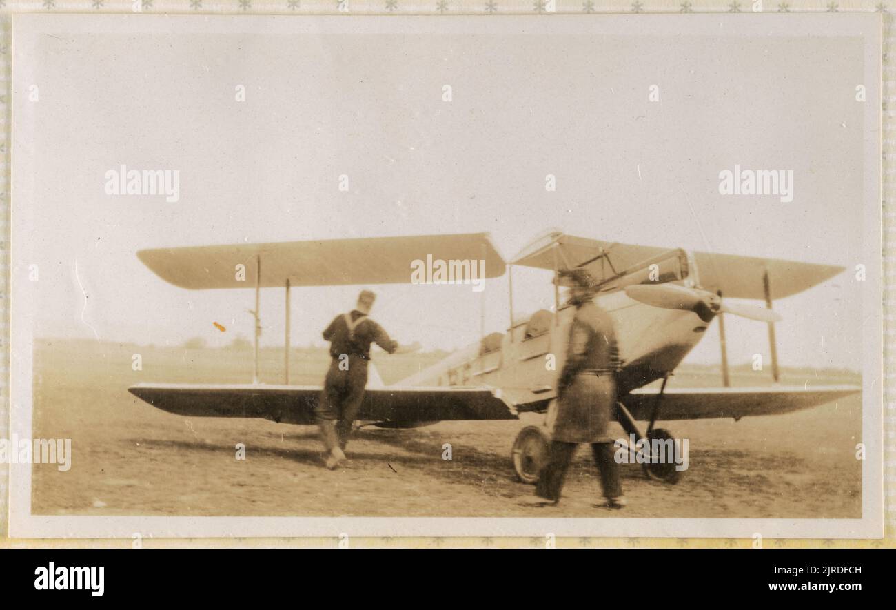 Men working on a biplane. From the album: James Cane photograph album ...