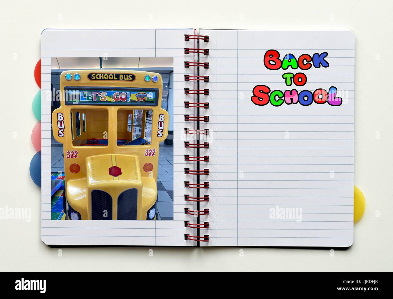 Open notebook with a photo of a school bus. Space for text. Back to ...