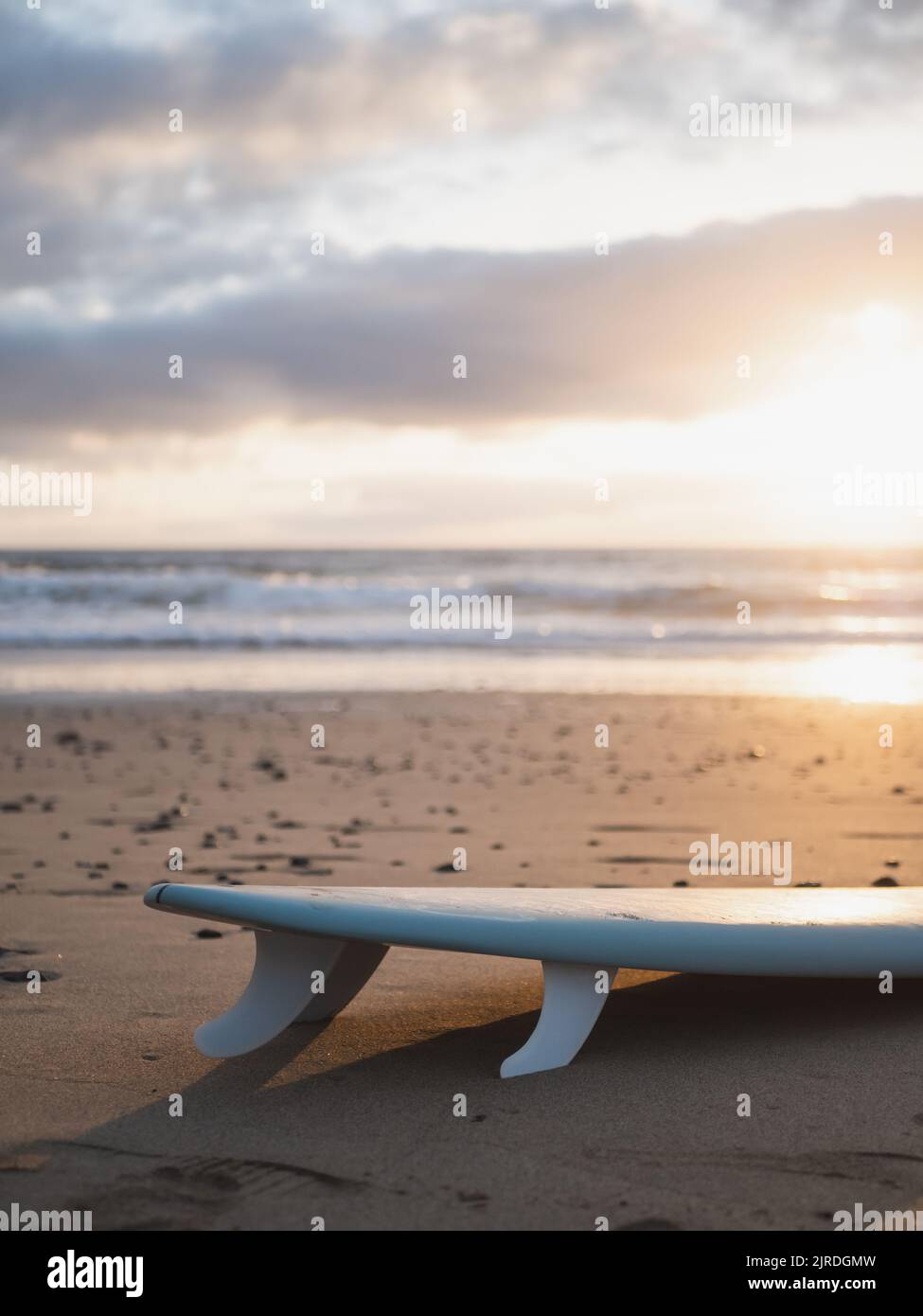 Surfboard lying on the beach close up Stock Photo - Alamy