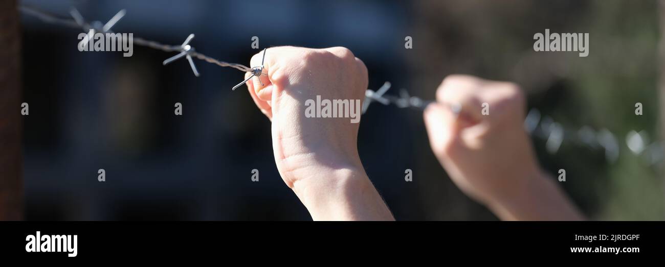 Hands on barbed wire hi-res stock photography and images - Alamy