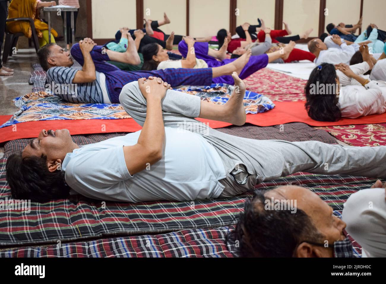 New Delhi, India, June 19 2022 -Group Yoga exercise session for people ...