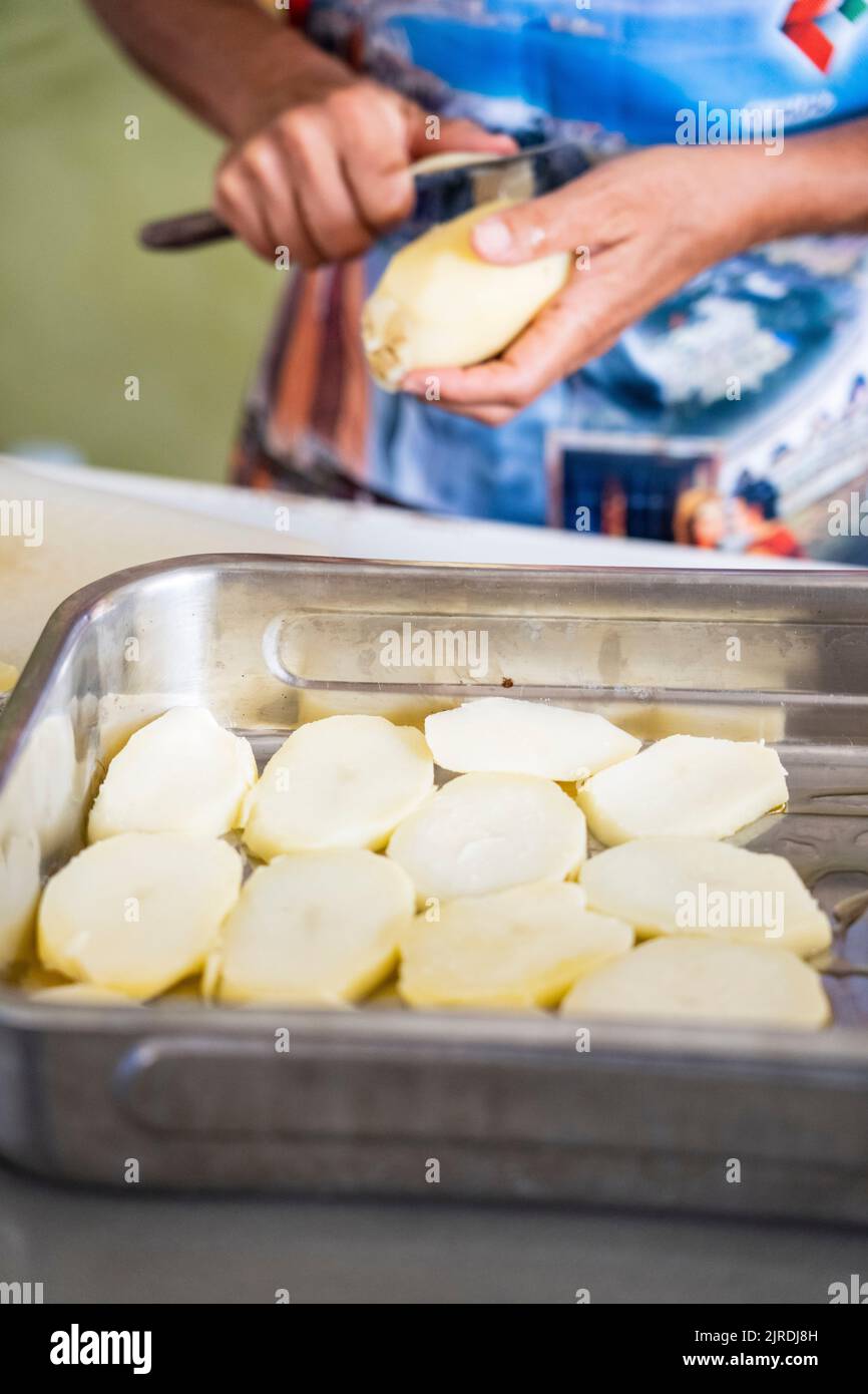cutting potatoes to cook moussaka, mallorca, spain Stock Photo - Alamy