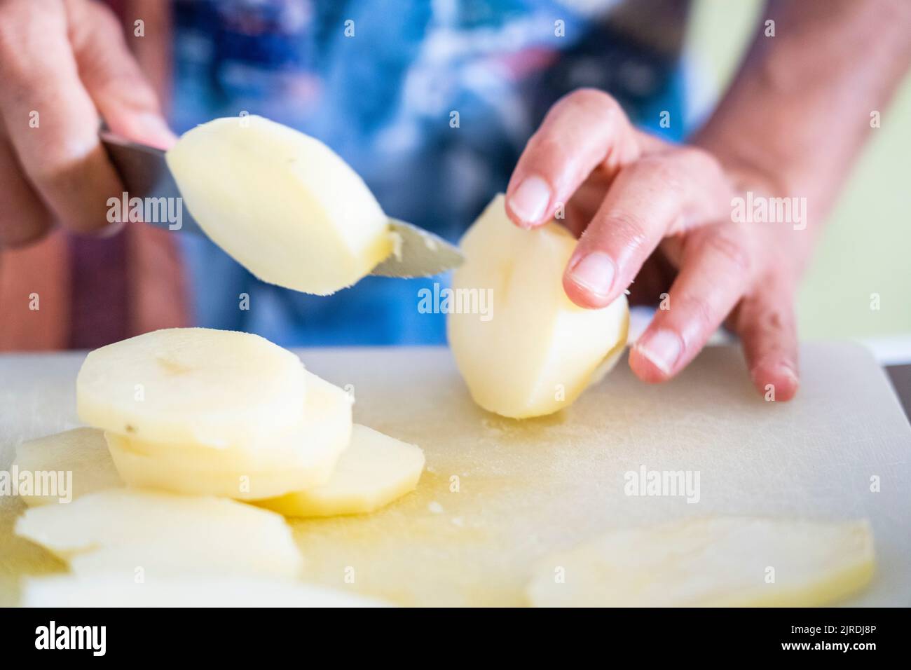 cutting potatoes to cook moussaka, mallorca, spain Stock Photo - Alamy