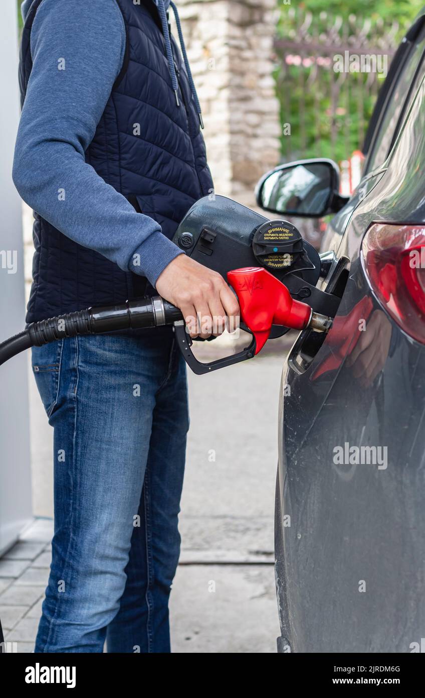 Fuel pump. Add fuel at Refueling station. Man's hand refuels car ...