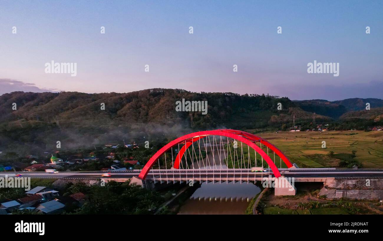 Aerial view of the Kalikuto Bridge, an Iconic Red Bridge at Trans Java Toll Road, Batang when ...
